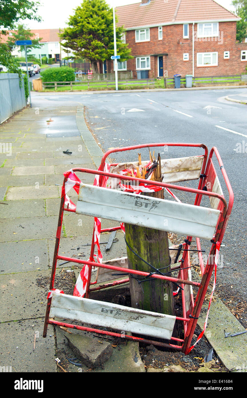 Damage caused by vehicle hitting telegraph pole at side of road Stock ...