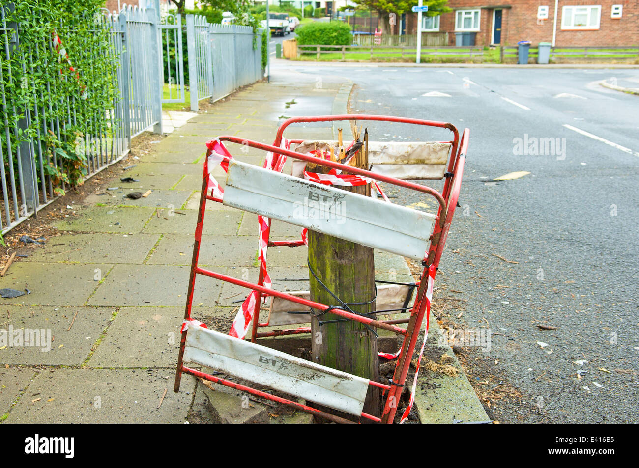 Damage caused by vehicle hitting telegraph pole at side of road Stock ...