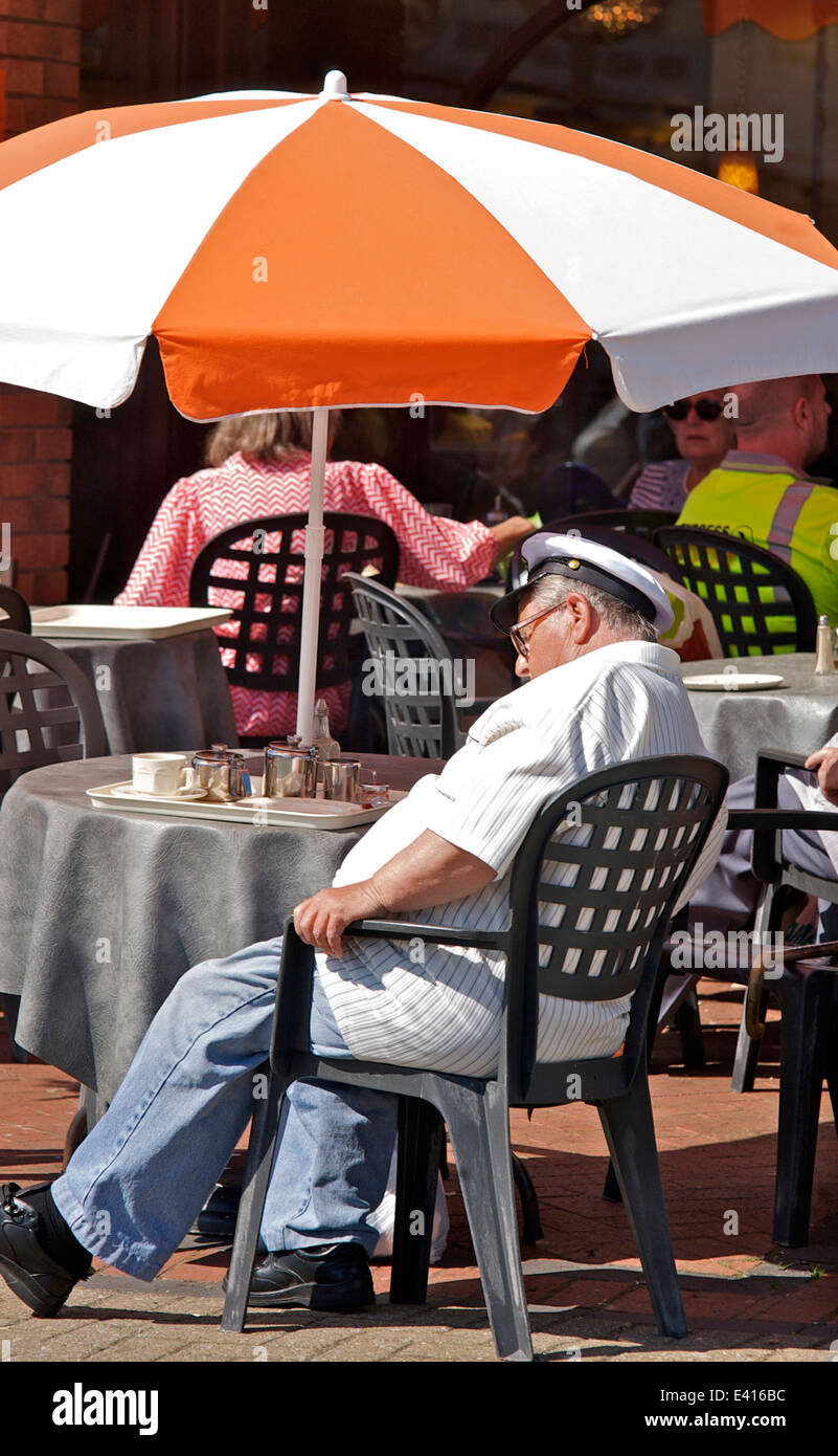 Senior man sleeping at outdoor restaurant table Stock Photo - Alamy
