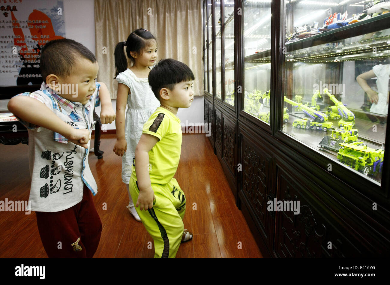 Shanghai. 2nd July, 2014. Children look at toys displayed at an old toy ...