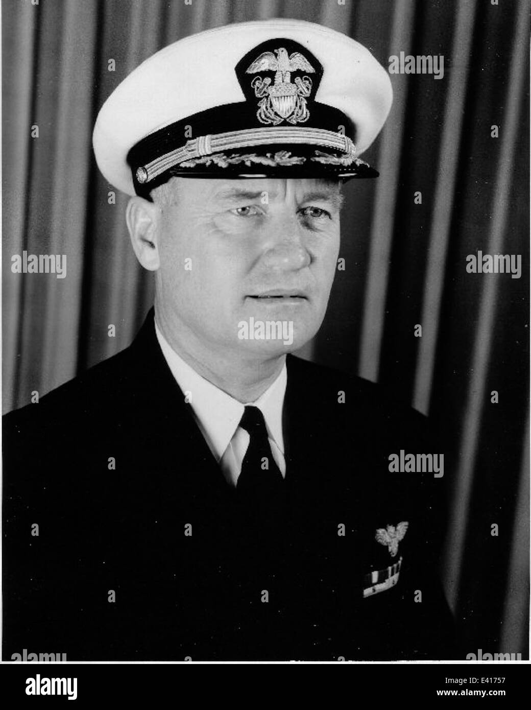 This photograph from 1961 captures Captain Fred L. Bates in front of a ...