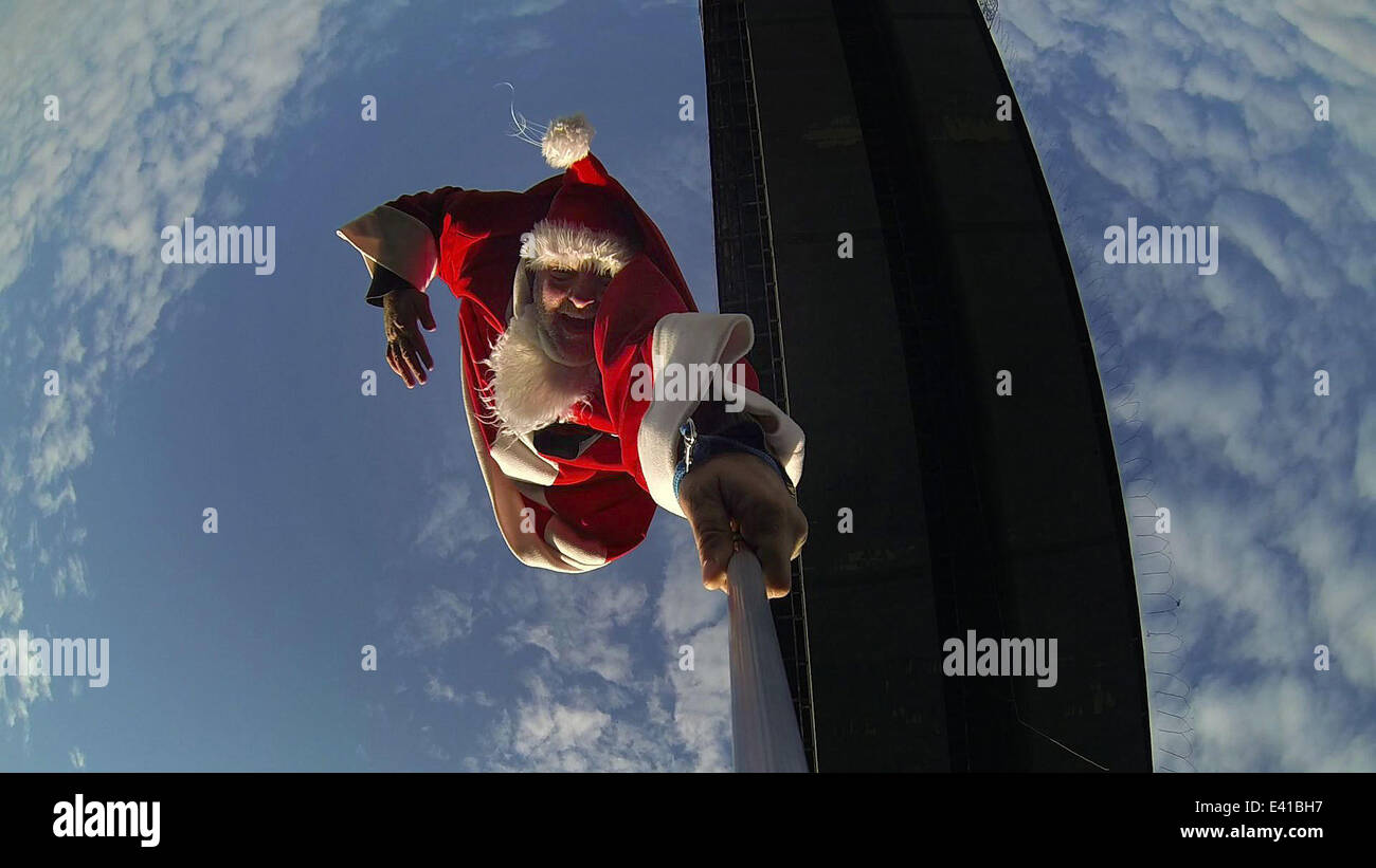 A man dressed like Santa Claus jumps over the 52 meters altitude ...