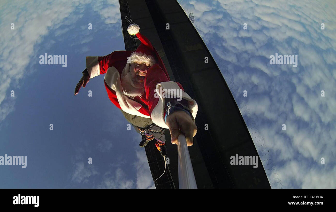 A man dressed like Santa Claus jumps over the 52 meters altitude ...