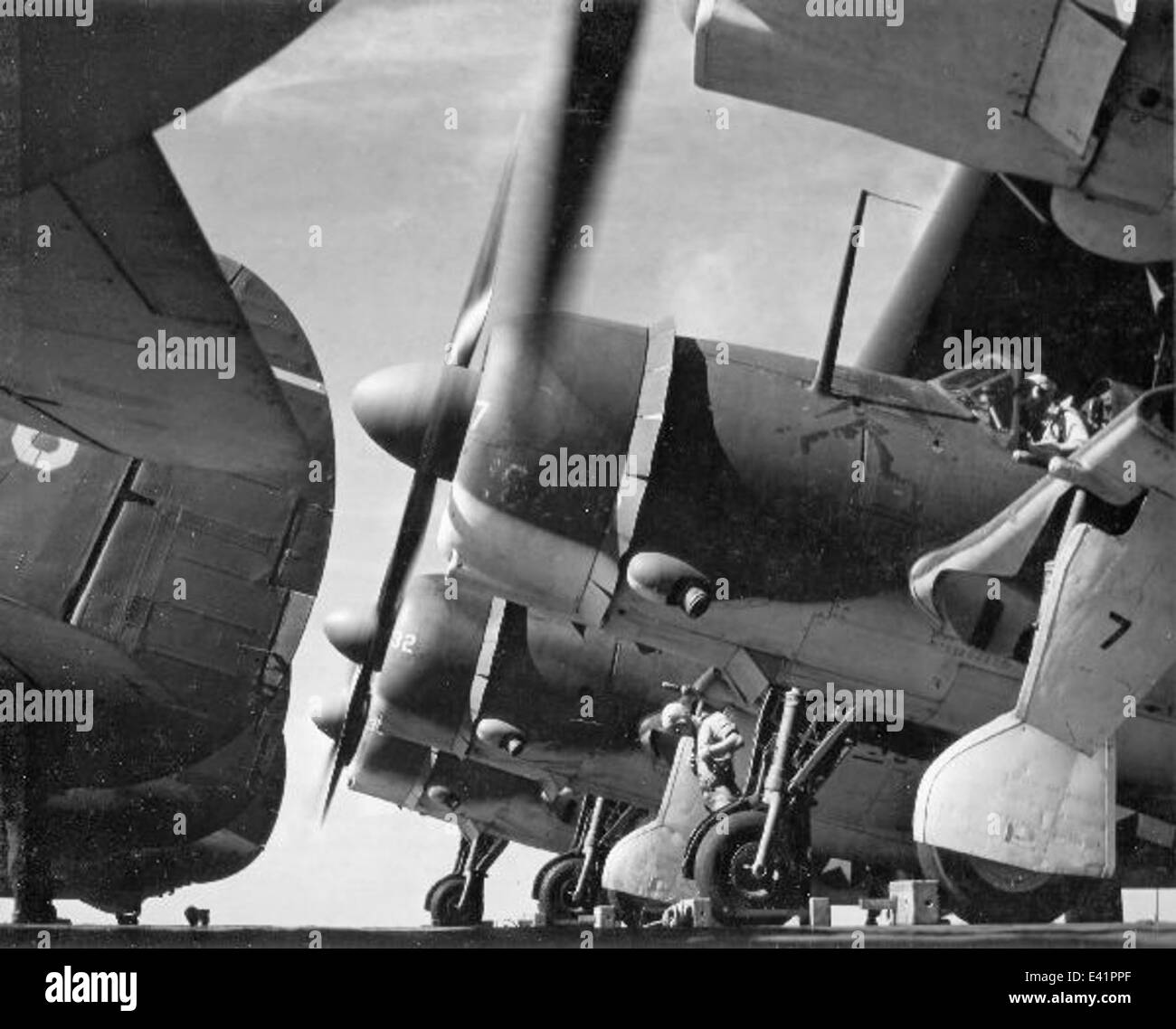 The photograph shows an SB2C-3 Helldiver aircraft undergoing a warm-up ...