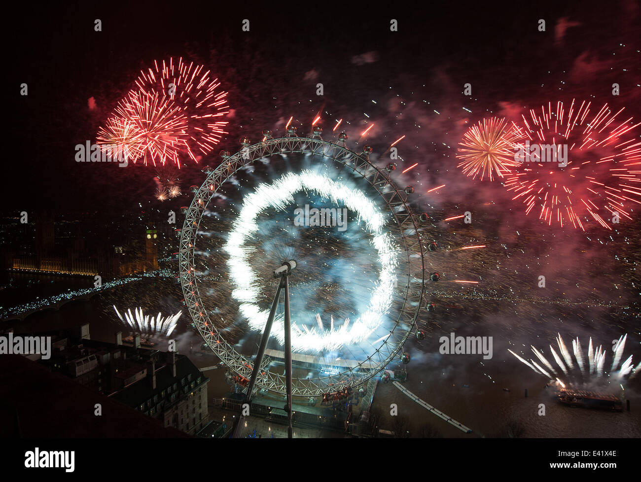 London New Year's fireworks over the river Thames and the London Eye ...