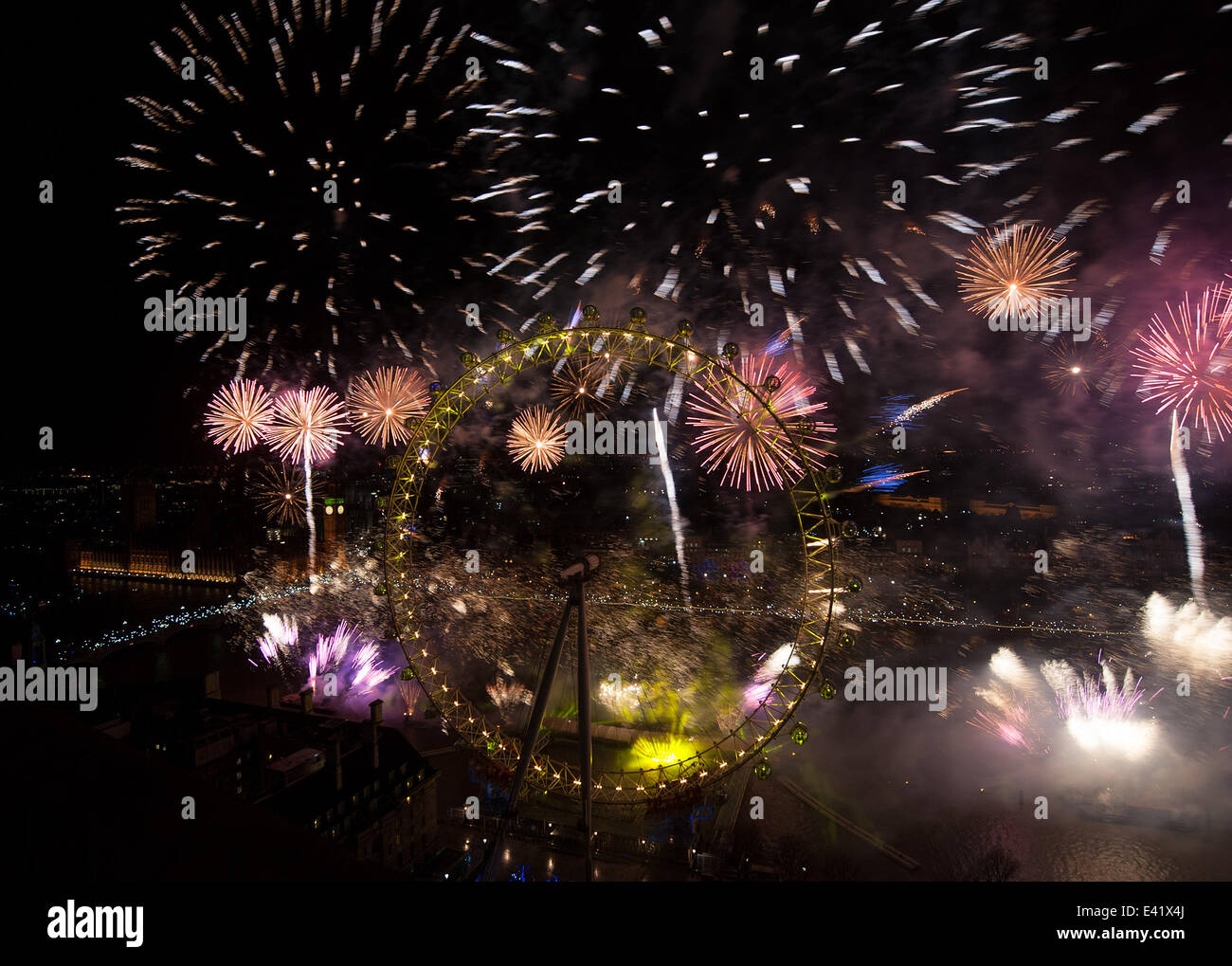 London New Year's fireworks over the river Thames and the London Eye ...
