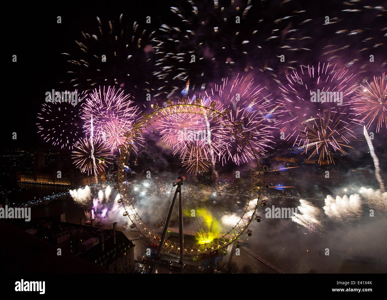 London New Year's fireworks over the river Thames and the London Eye ...