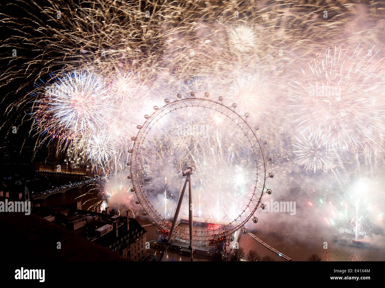 London New Year's fireworks over the river Thames and the London Eye ...