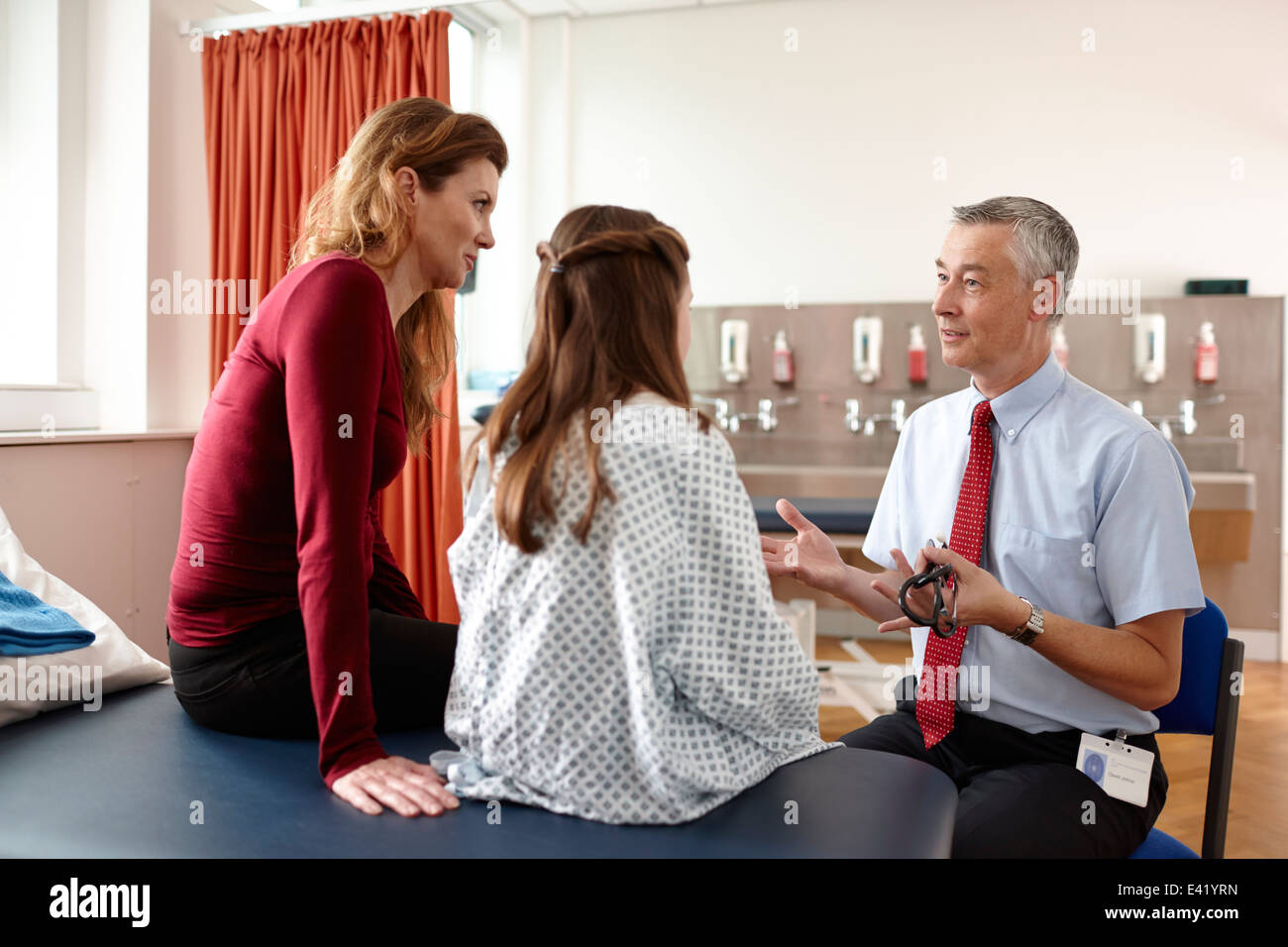 Doctor talking to patient and mother Stock Photo - Alamy