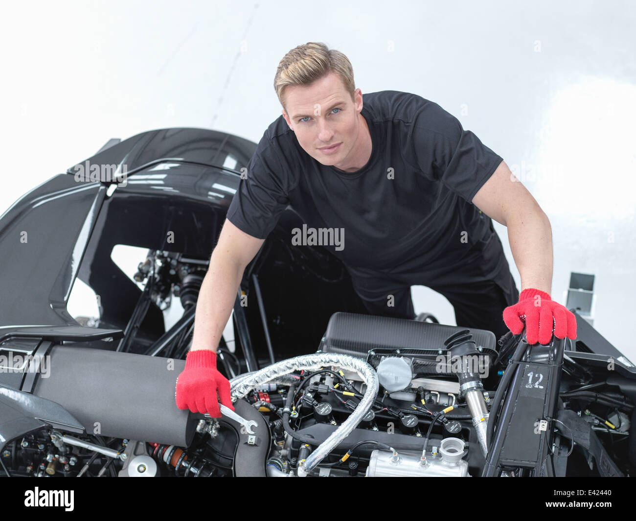 Portrait of engineer assembling supercar in sports car factory Stock ...