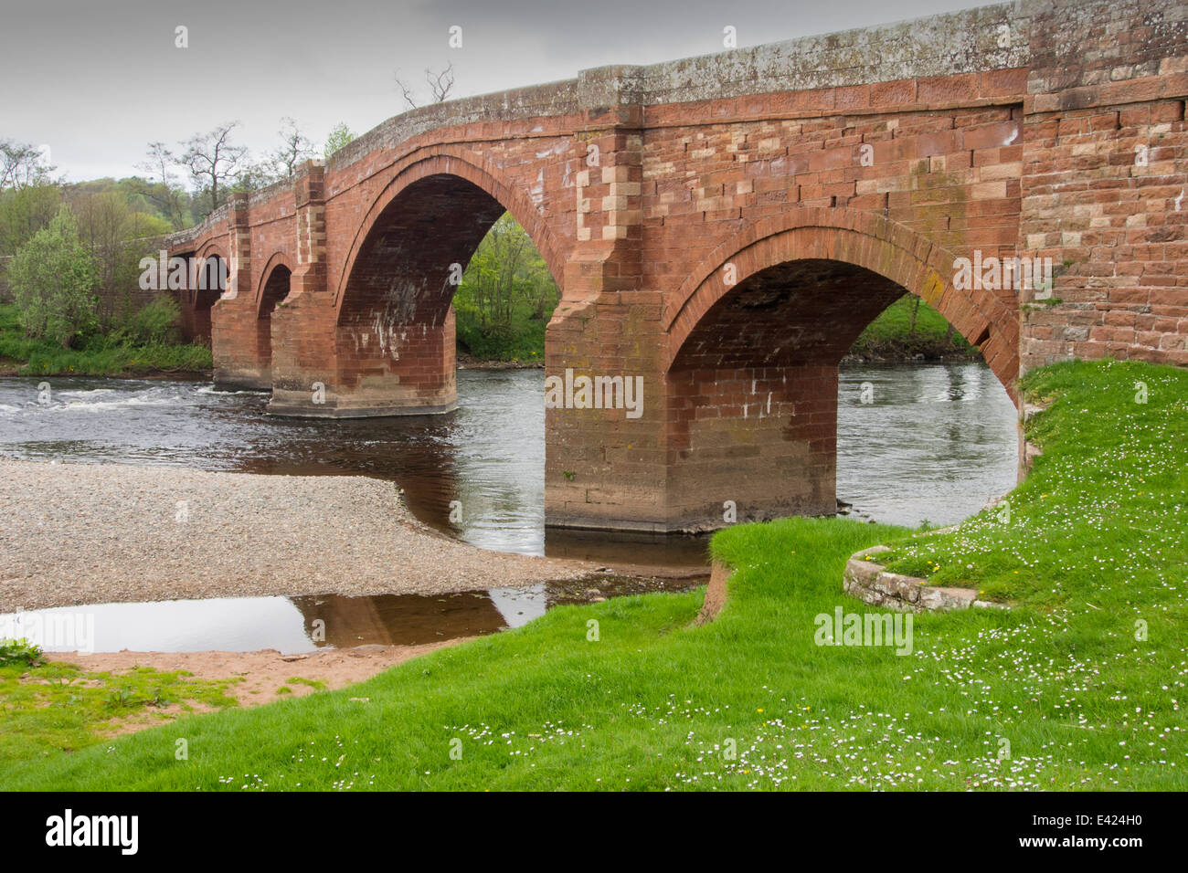 An old red sandstone bridge across the river Eden at Kirkoswold ...