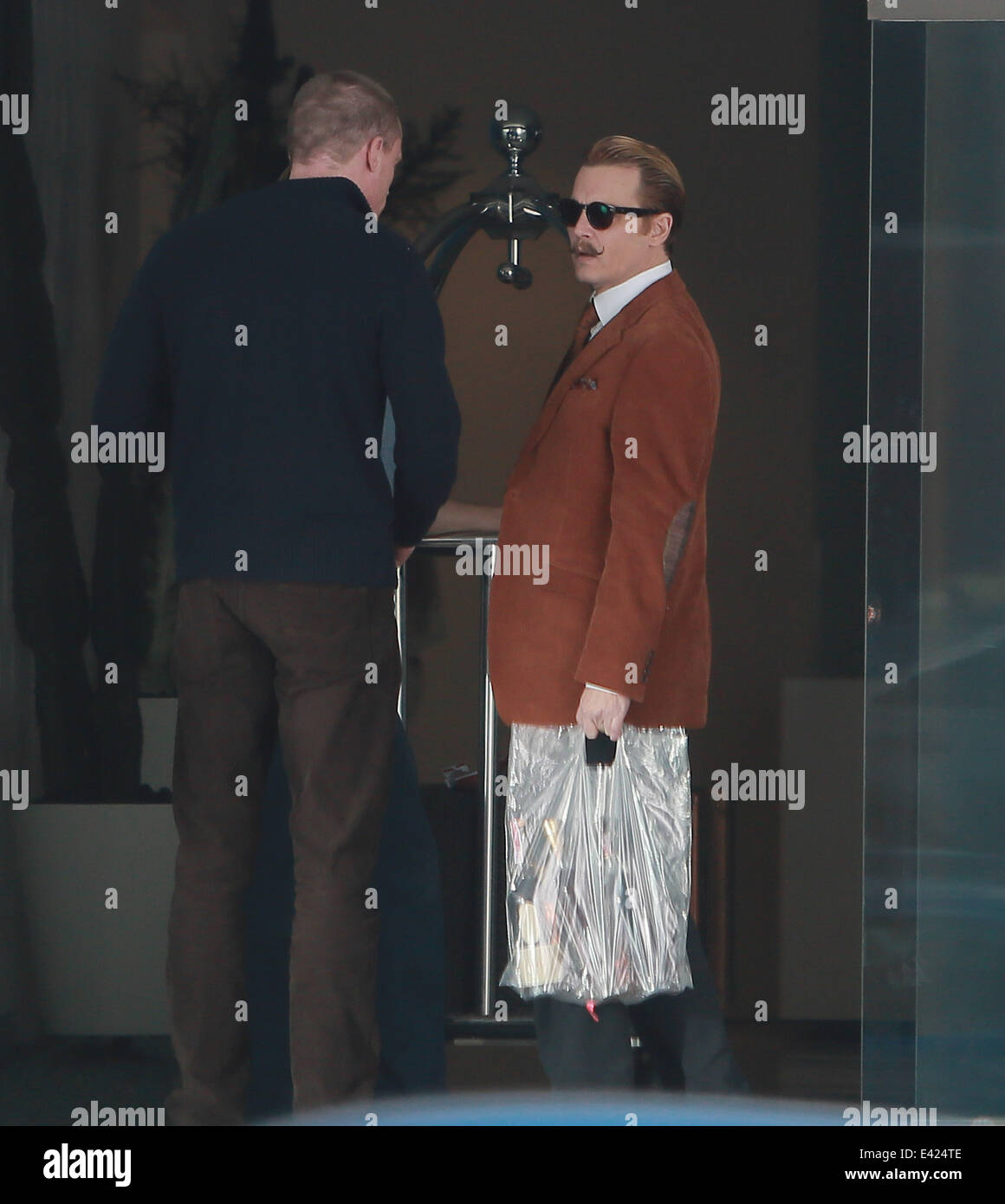 Johnny Depp filming on the set of 'Mortdecai' carrying a gold top cane ...