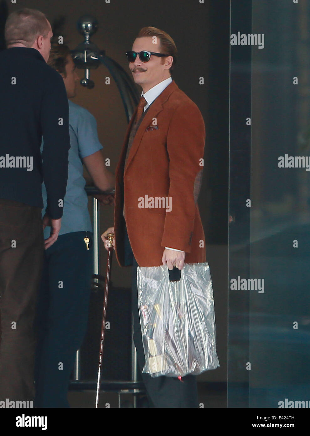 Johnny Depp filming on the set of 'Mortdecai' carrying a gold top cane ...