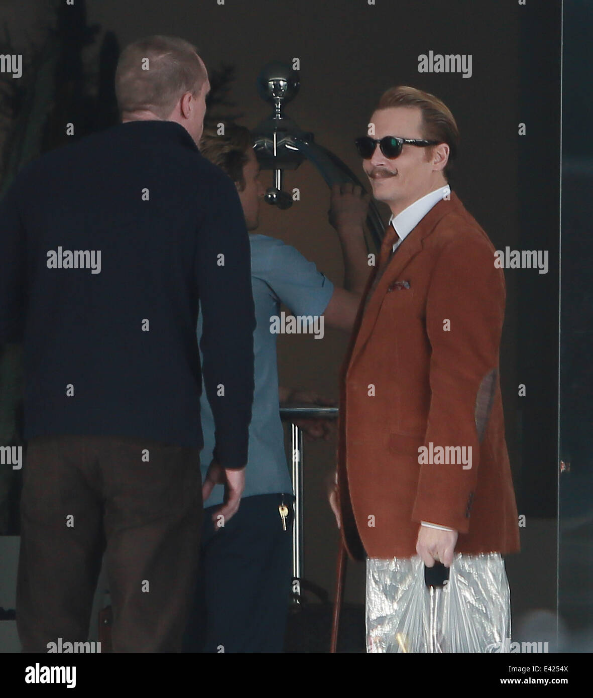 Johnny Depp filming on the set of 'Mortdecai' carrying a gold top cane ...