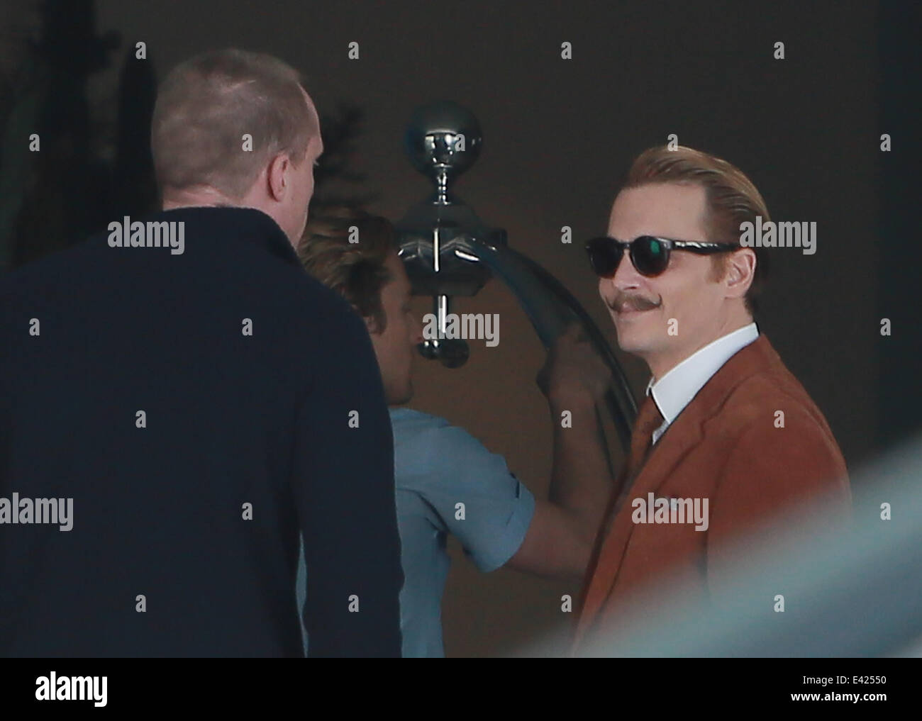 Johnny Depp filming on the set of 'Mortdecai' carrying a gold top cane ...