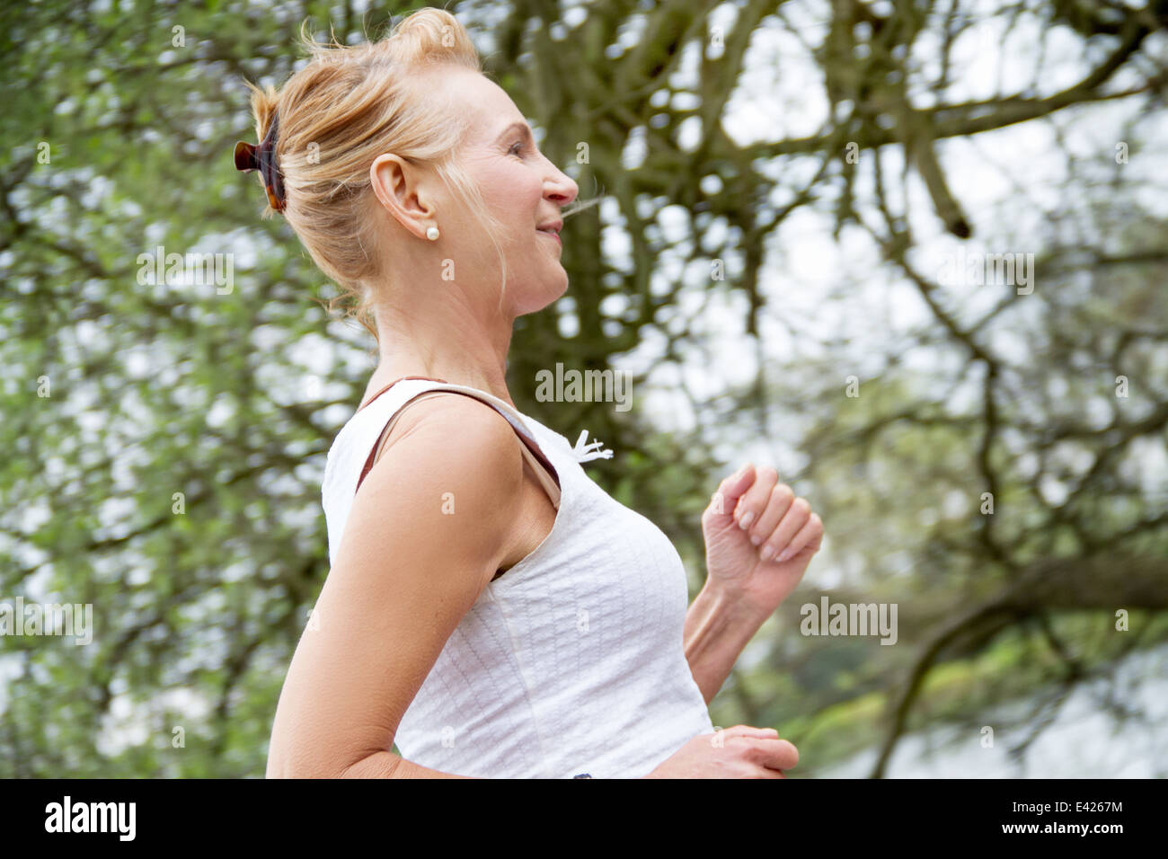 Woman mature running outdoors park hi-res stock photography and images ...