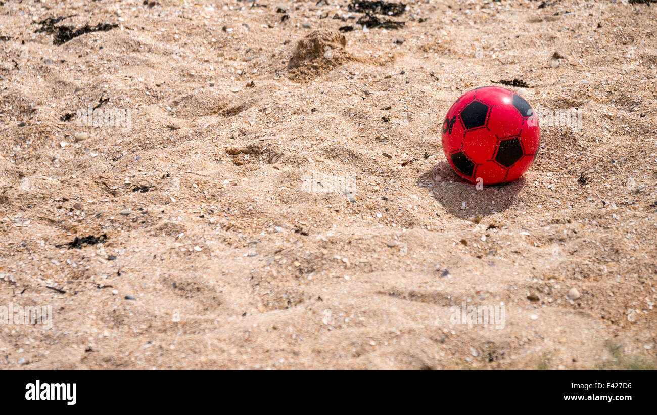 Red Football on Beach Stock Photo - Alamy