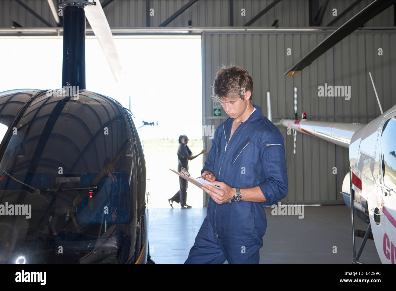 Student pilot checking details on clipboard Stock Photo - Alamy