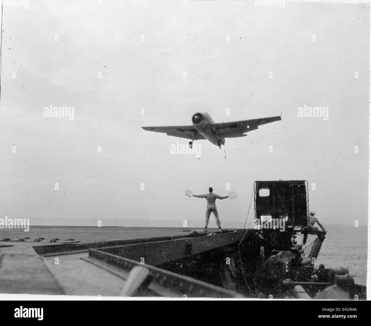 A photograph of a TBF Avenger aircraft passing inspection on the USS ...