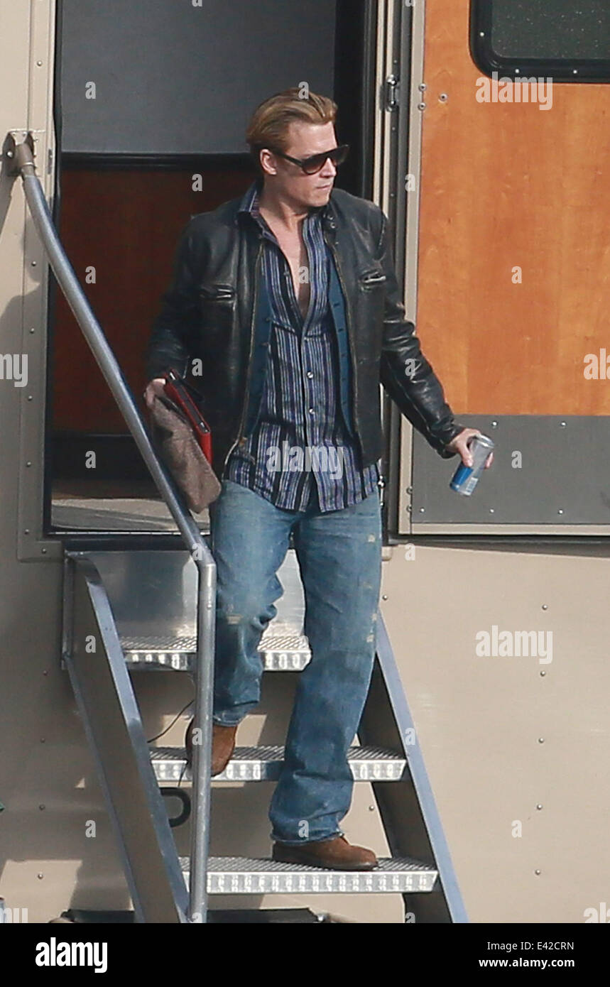 A clean shaven Johnny Depp shows a bit of paunch while leaving his ...