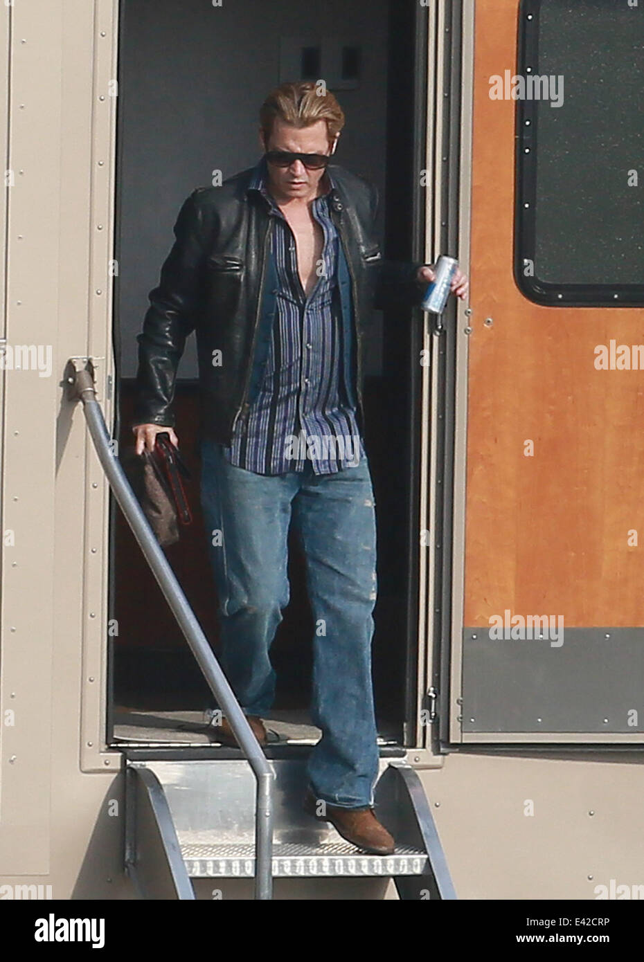 A clean shaven Johnny Depp shows a bit of paunch while leaving his ...
