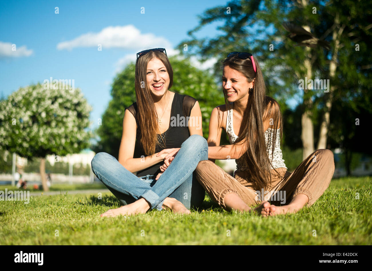Two young female best friends laughing in park Stock Photo - Alamy