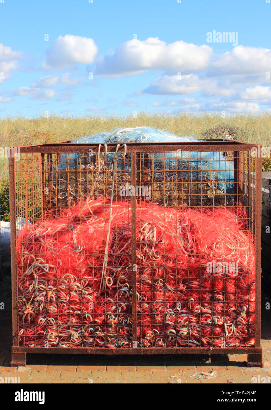 Red industry fishing net in rusty metal grid Stock Photo - Alamy