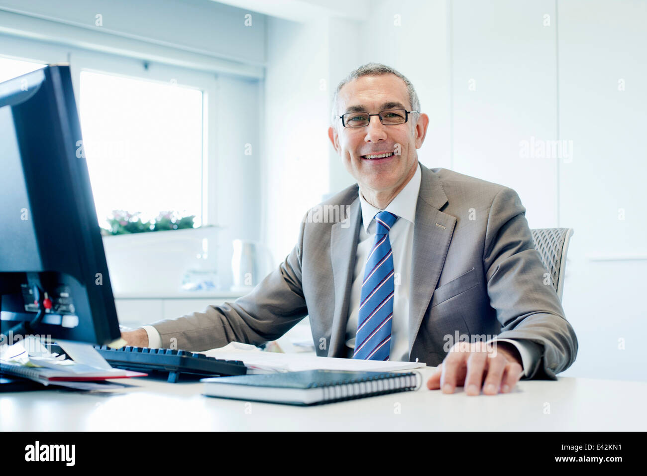 Businessman at office desk Stock Photo - Alamy