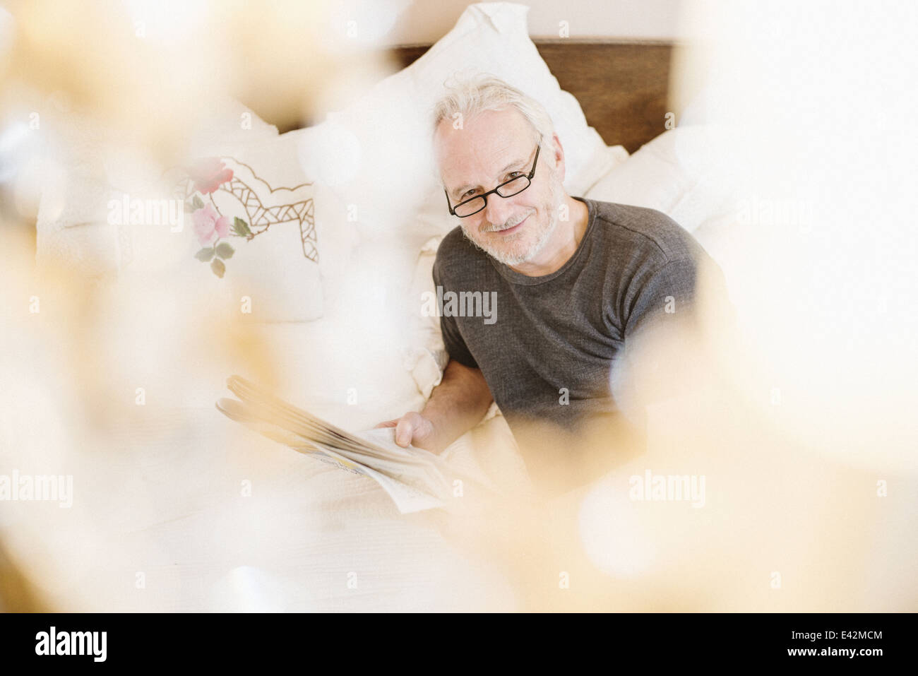 Senior man reading newspaper, smiling Stock Photo - Alamy