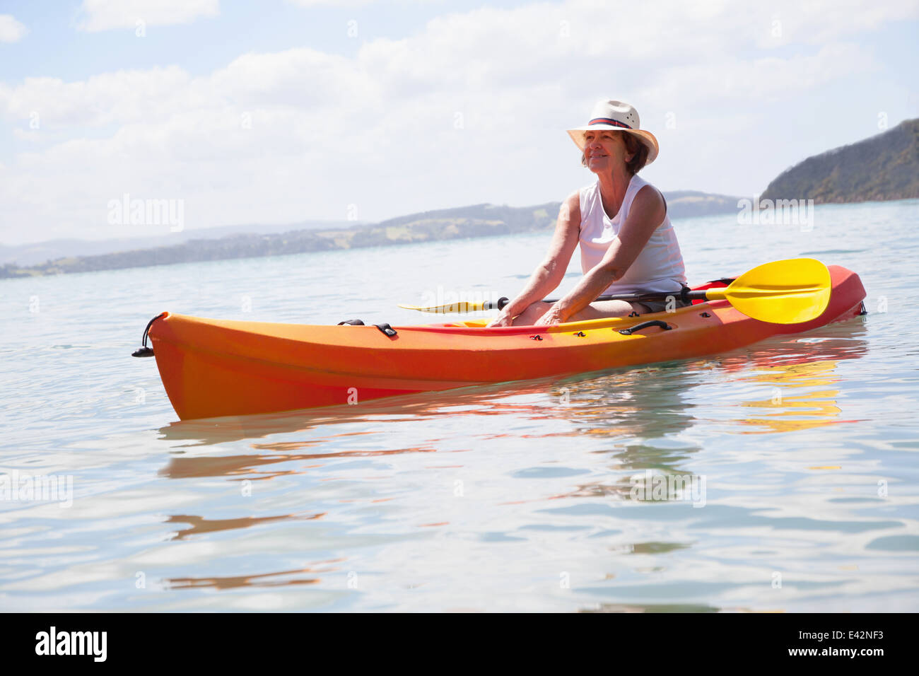 Senior woman sea kayaking Stock Photo - Alamy