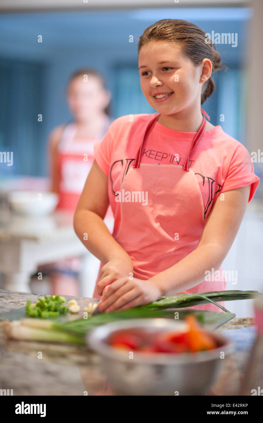 Teenage girl preparing leeks in kitchen Stock Photo - Alamy