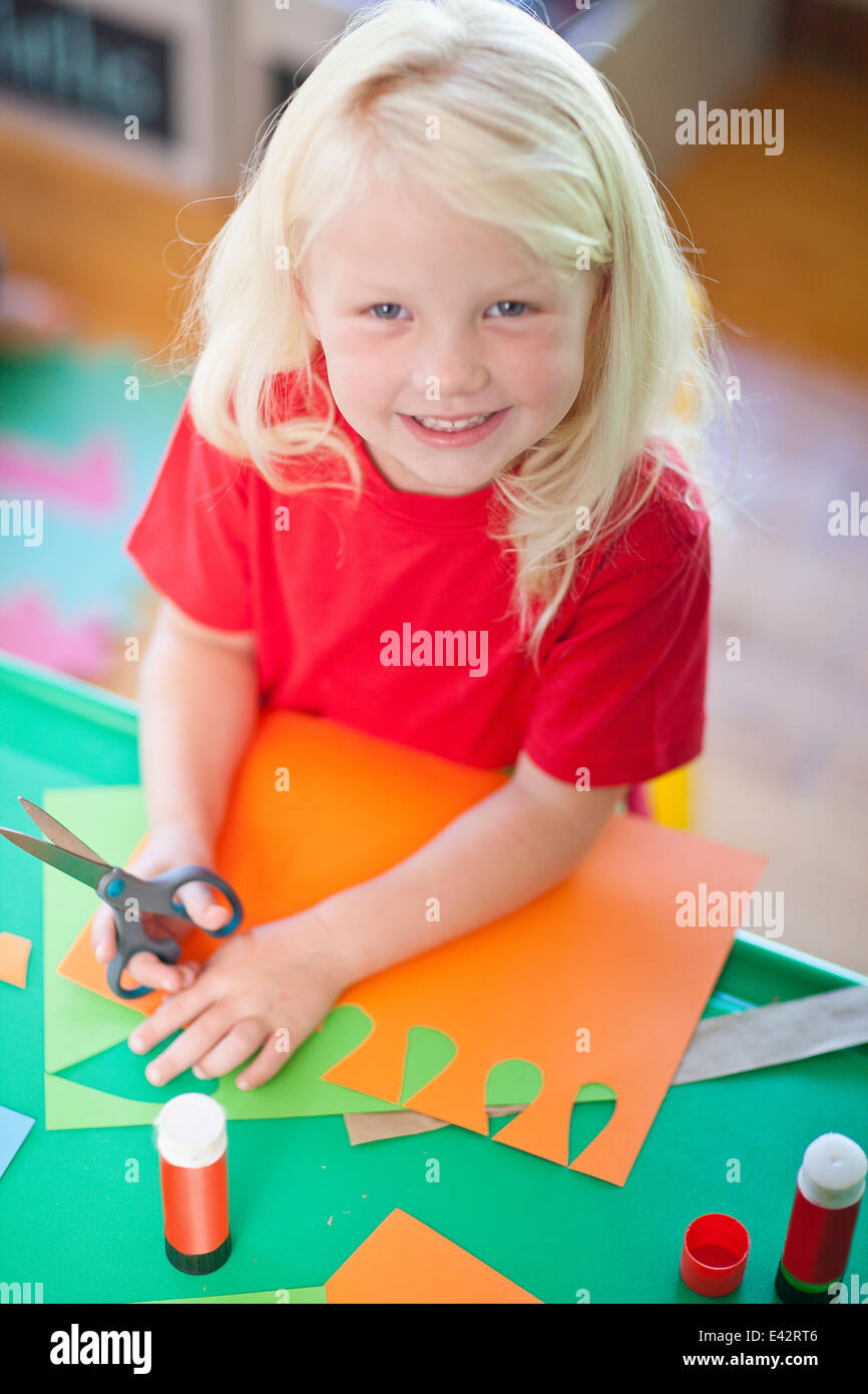Portrait of girl cutting shapes at nursery school Stock Photo - Alamy