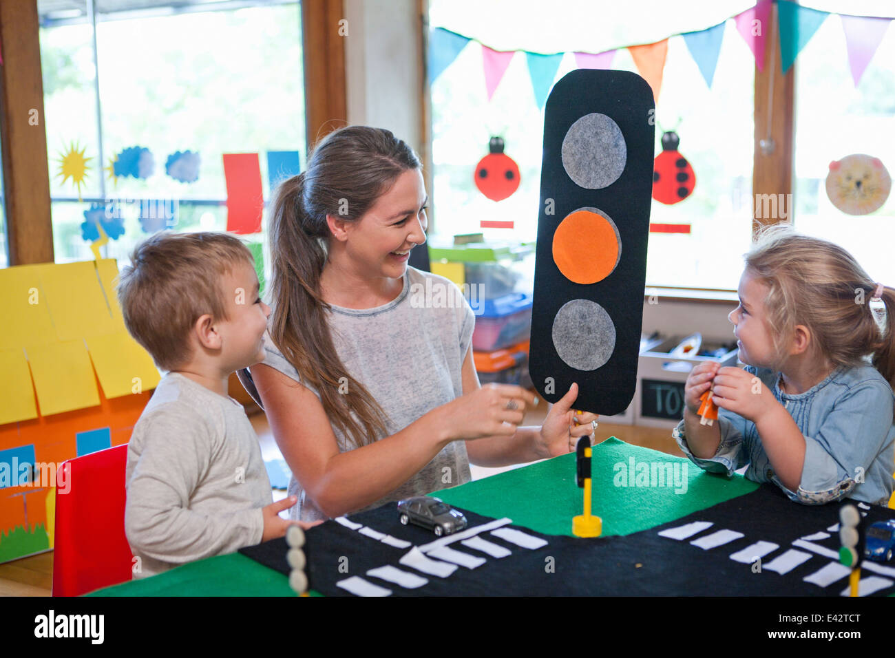 Teacher and pupils learning road crossing at nursery school Stock Photo ...