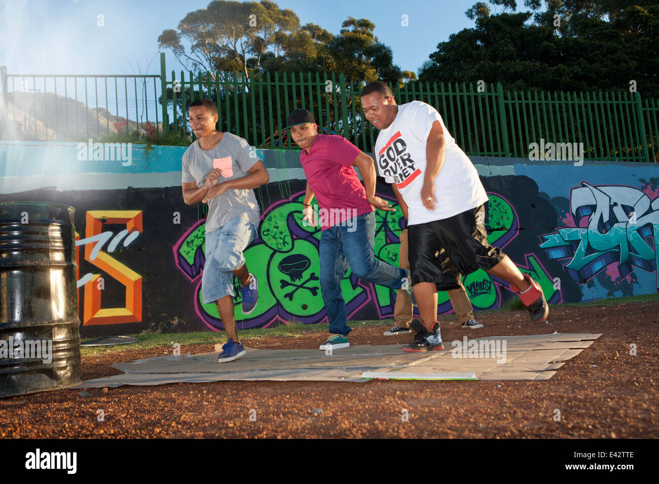 Group of four men breakdancing in park at dusk Stock Photo - Alamy