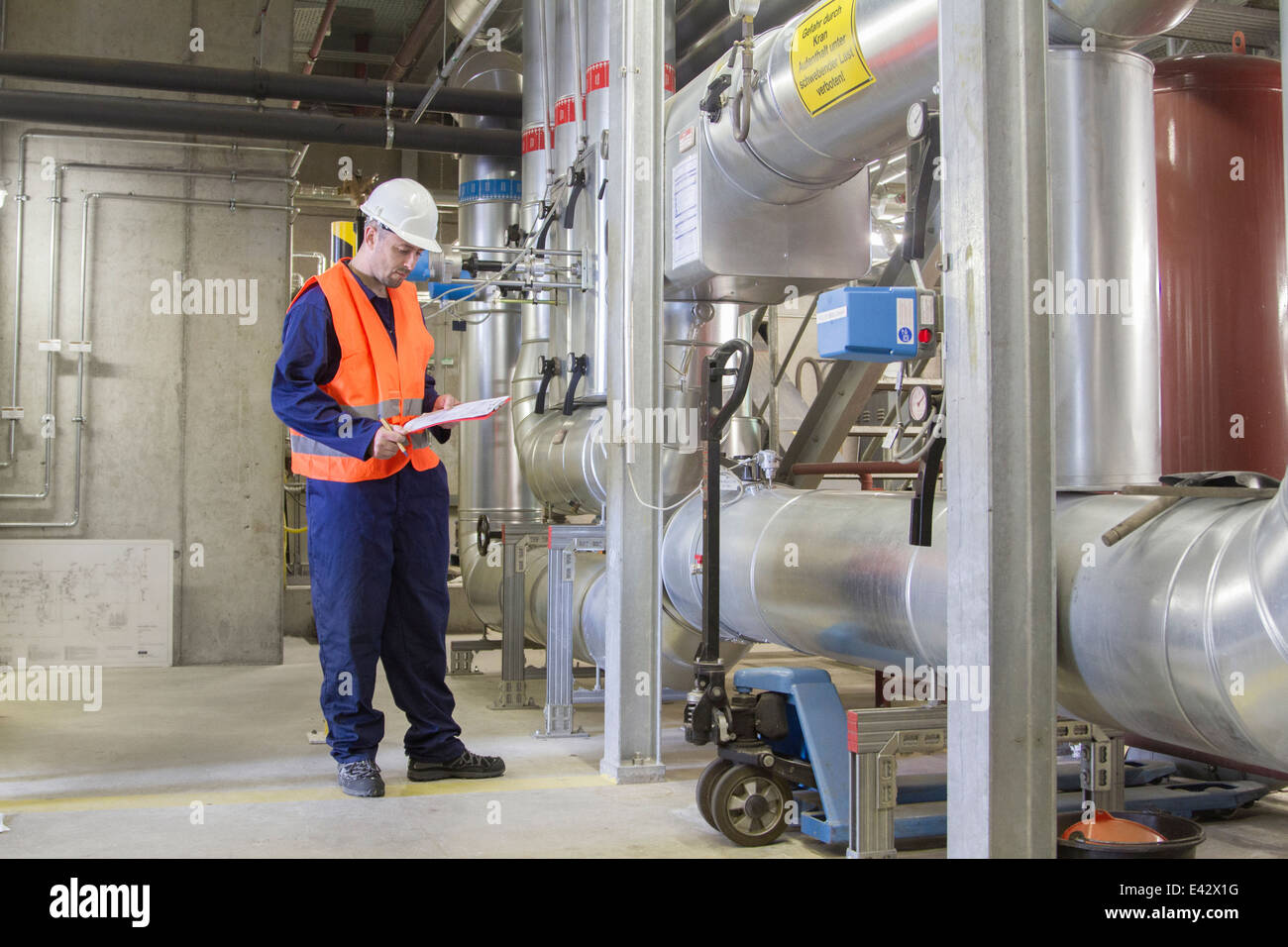 Technician checking paperwork in power station Stock Photo - Alamy