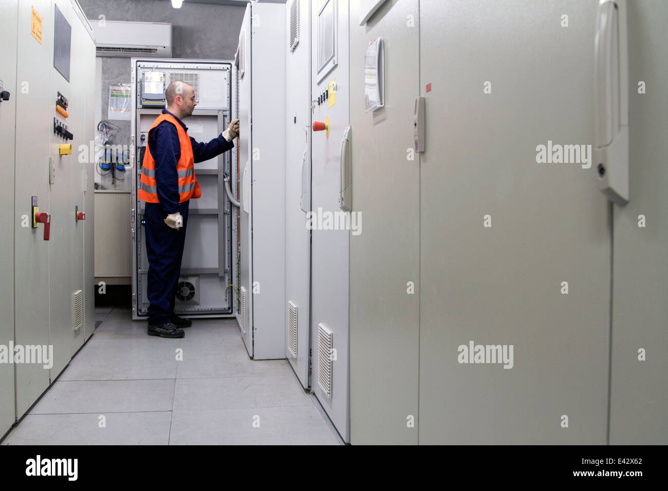 Technician doing a check in power station control room Stock Photo - Alamy