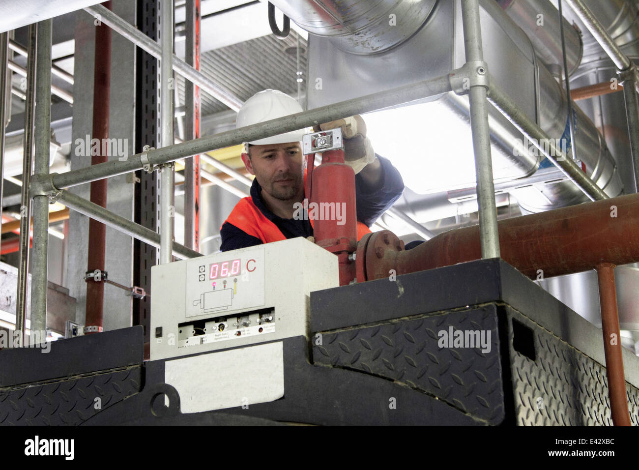 Technician on walkway doing check in power station Stock Photo - Alamy