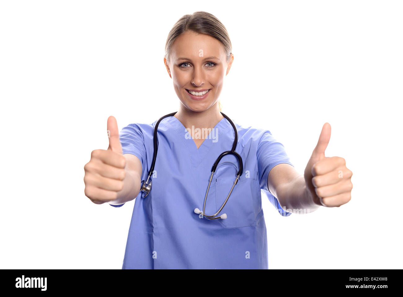 Young female nurse or doctor in blue scrubs holding up her thumbs to ...