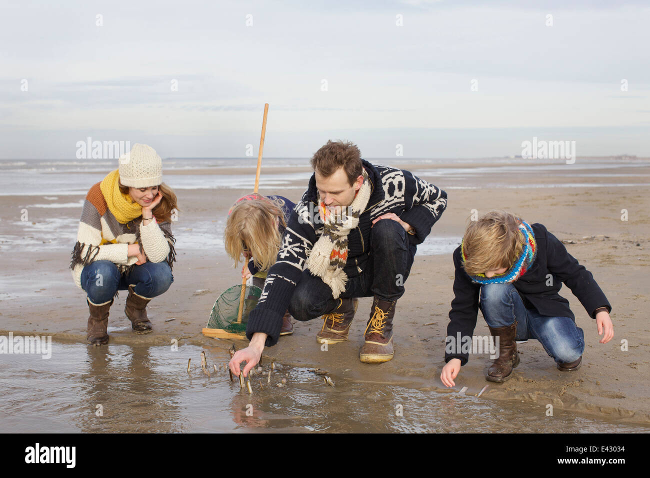 Child learning from parents hi-res stock photography and images - Alamy
