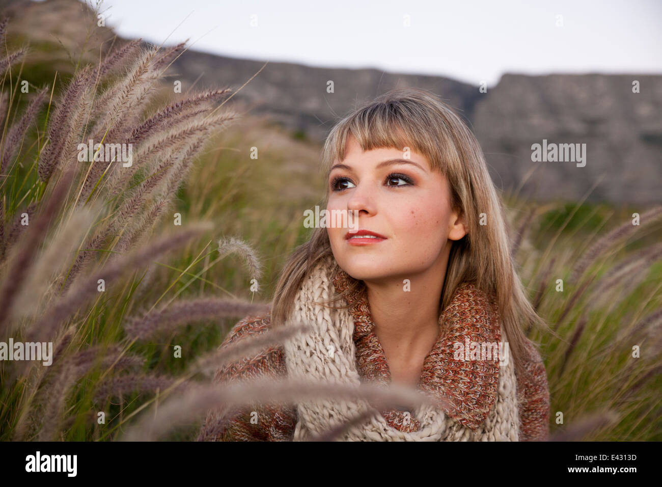 Portrait of beautiful young woman gazing from marsh grasses Stock Photo ...
