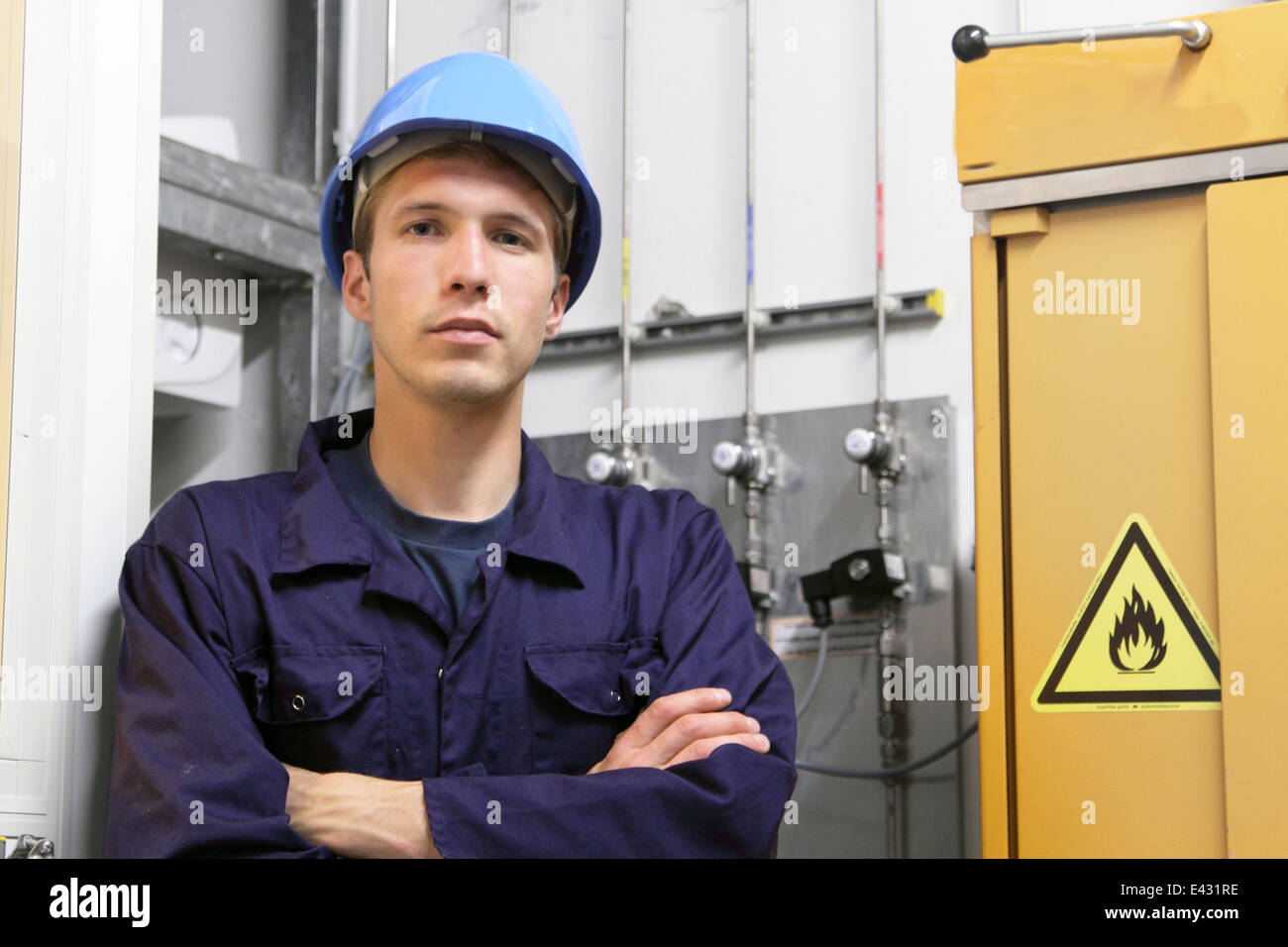 Portrait of confident male electrician in factory Stock Photo - Alamy