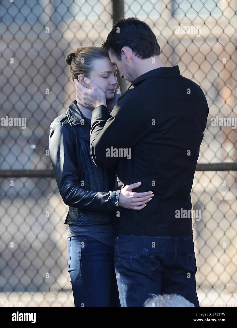 Actress Emily Vancamp smooches with her co star Barry Sloane on the set ...