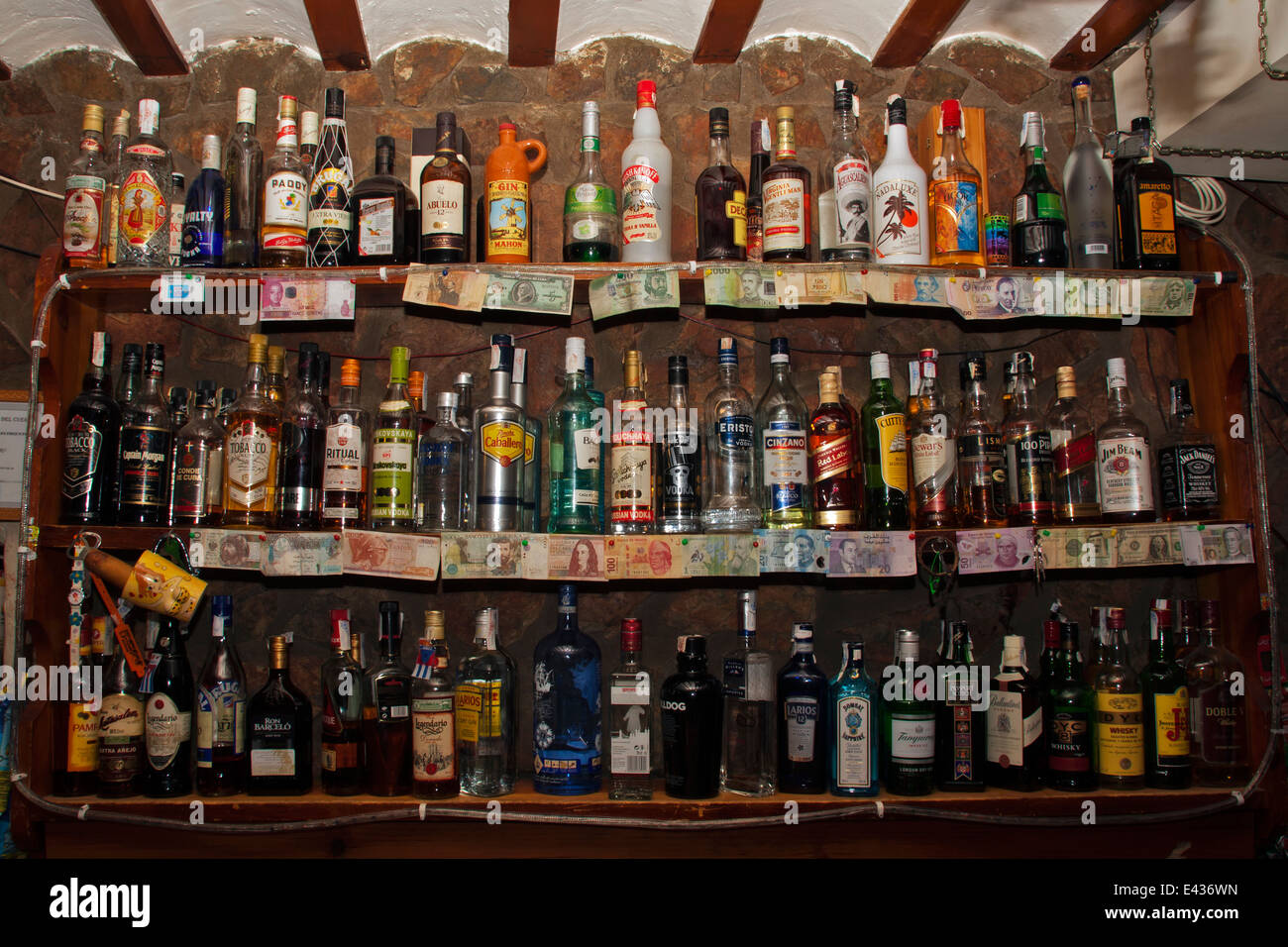 Shelf with many alcoholic drinks behind the bar Stock Photo - Alamy