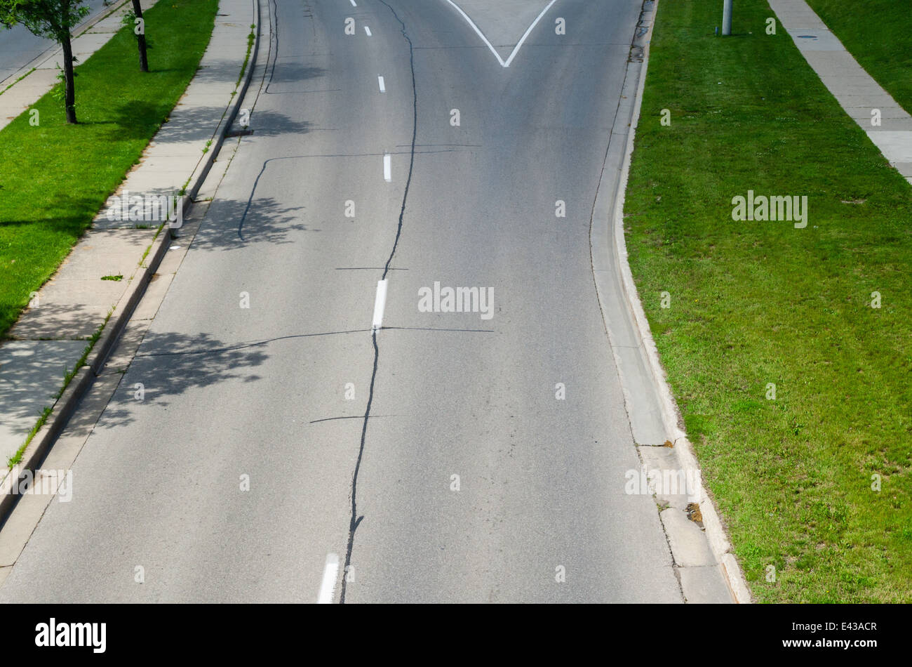 Street with right turn exit between grass shoulders Stock Photo - Alamy