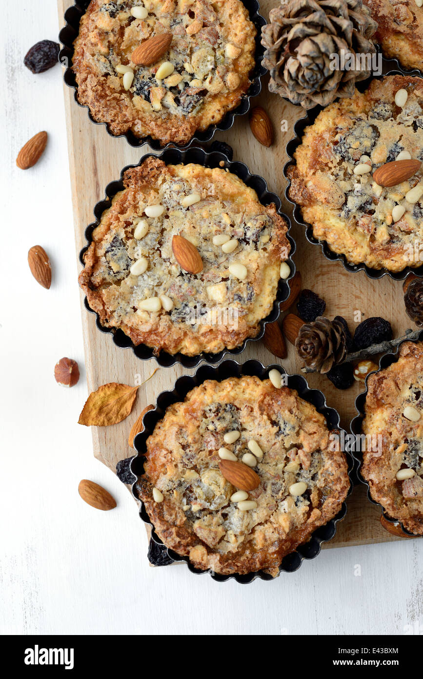 Small tarts in metal shapes, shells filled with nuts and raisins ...