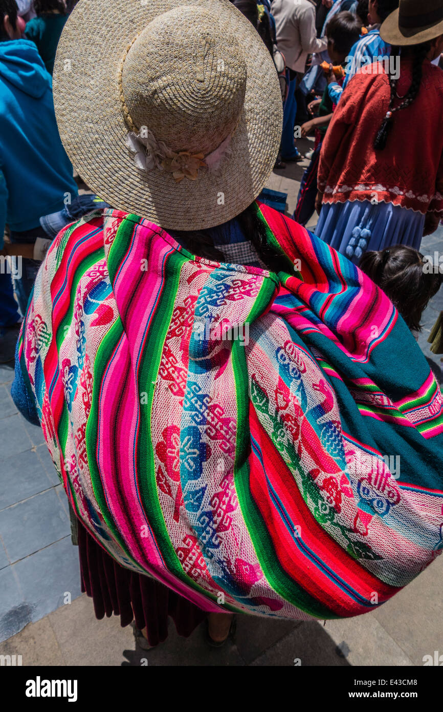 The backside of a Bolivian woman wearing a traditional textile, a multi ...