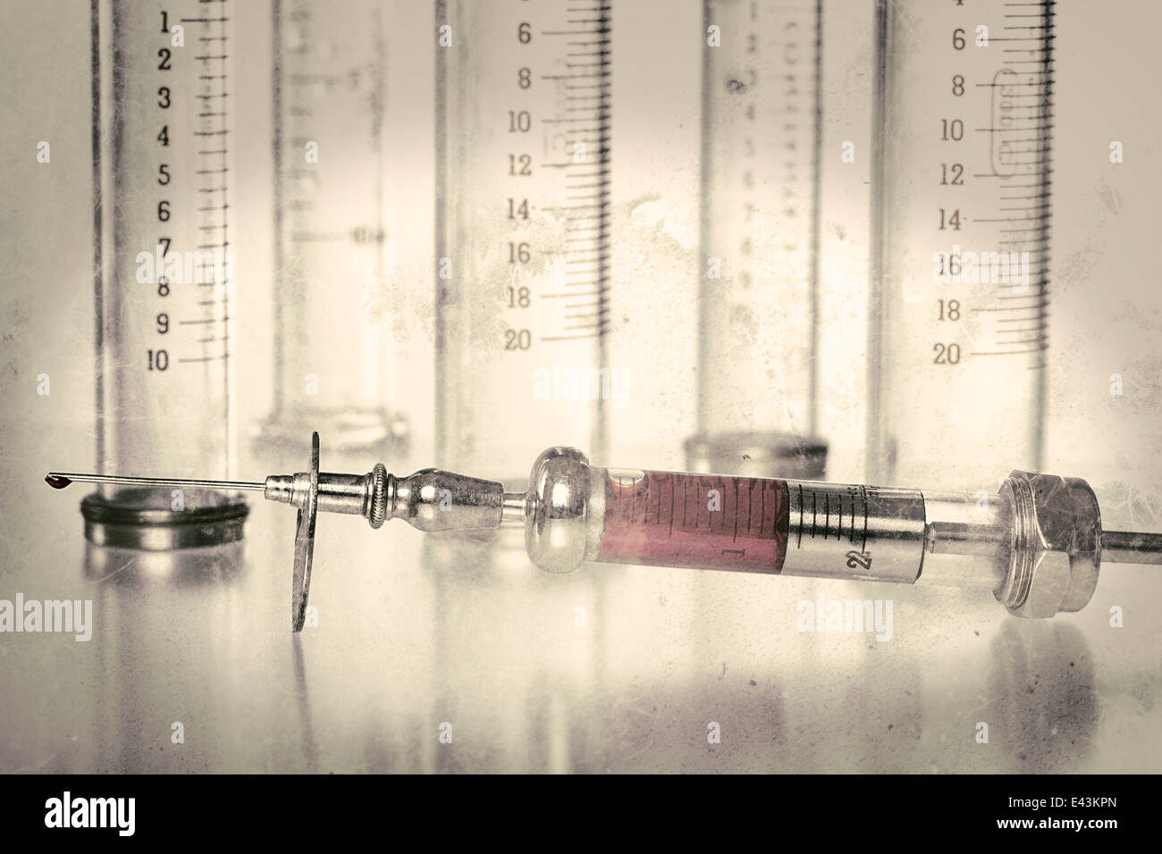 vintage syringe with blood and empty glass syringes in background Stock ...