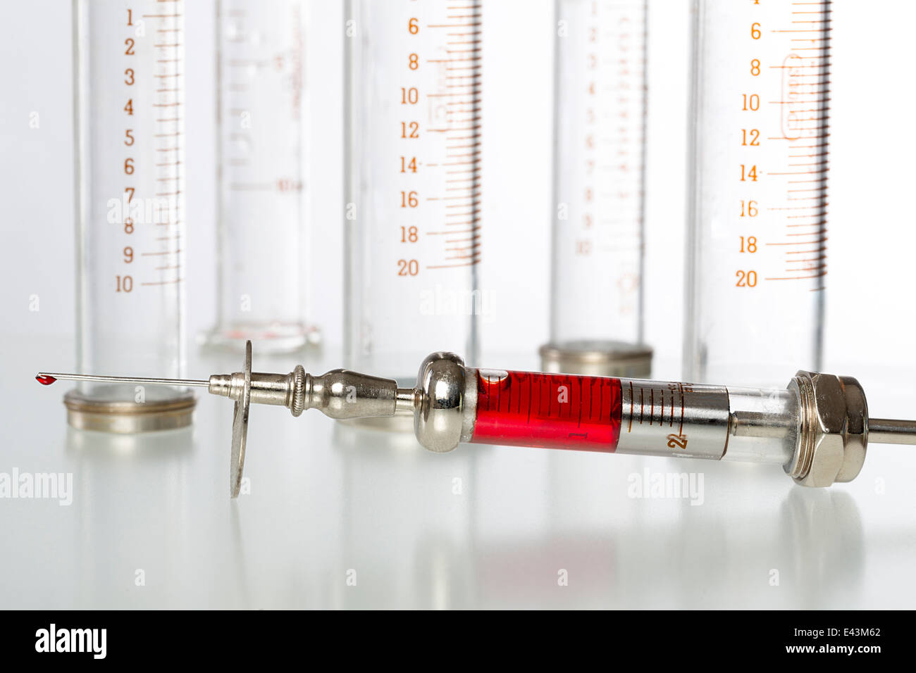 syringe with blood and empty glass syringes in background Stock Photo ...