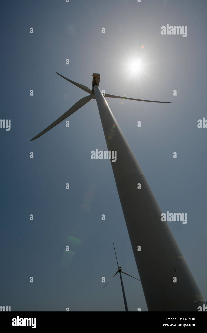 Wind turbine blades pass by the sun at noon near Lanjaron, in Andalucia ...