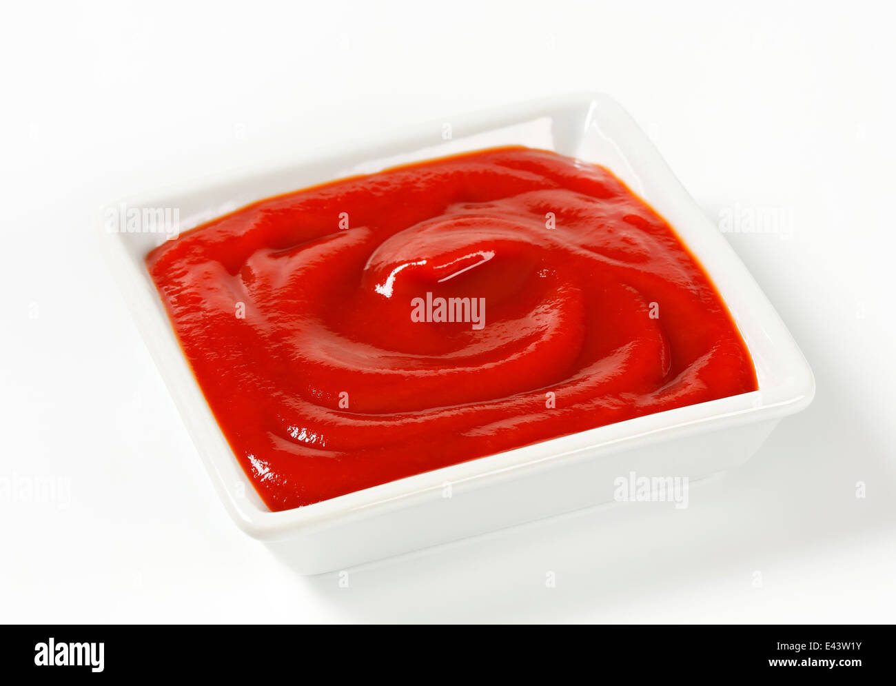 Smooth tomato passata in a small square dish Stock Photo - Alamy